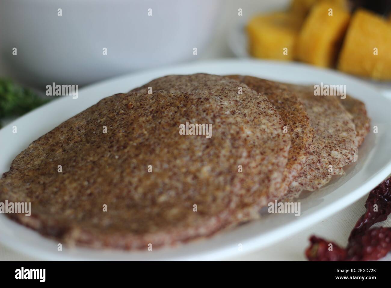 Home made Finger millet pancakes served with black chickpea gravy and ...