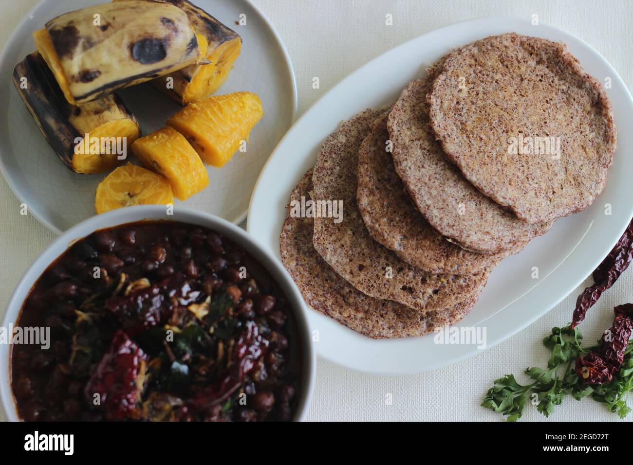 Home made Finger millet pancakes served with black chickpea gravy and ...