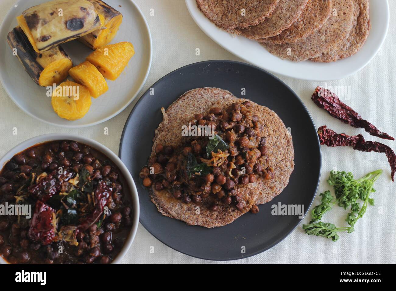 Home made Finger millet pancakes served with black chickpea gravy and ...