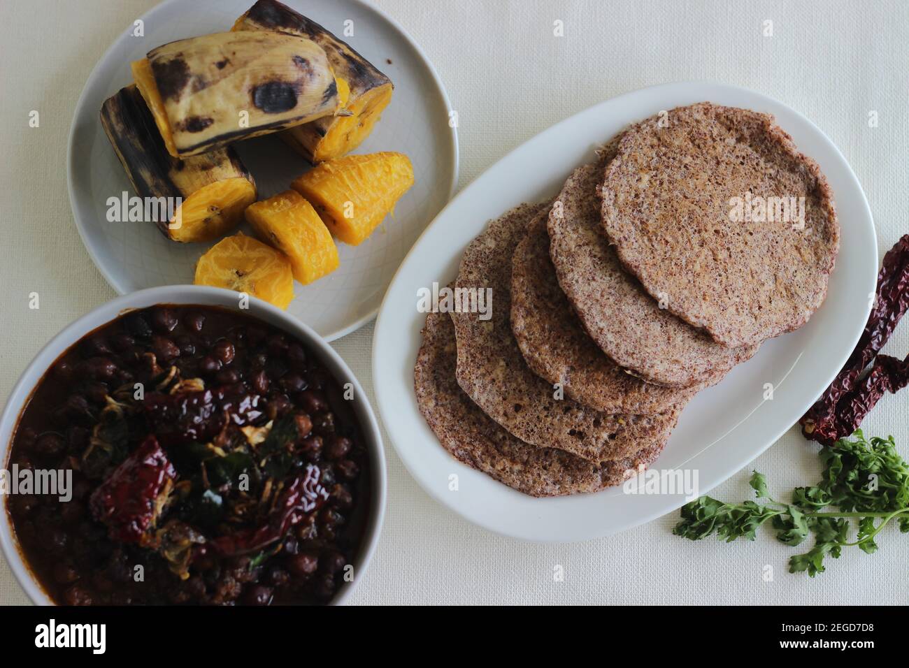 Home made Finger millet pancakes served with black chickpea gravy and ...