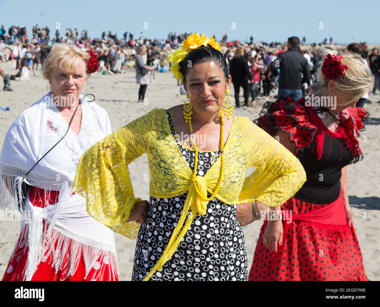 Women dressed in a colorful Gypsy style watch the procession Stock ...