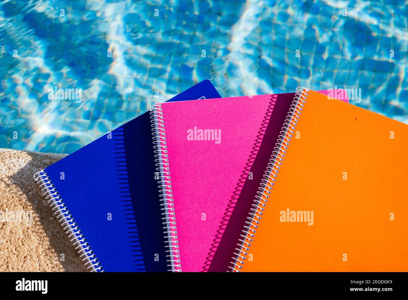 colored notebooks next to a pool Stock Photo - Alamy