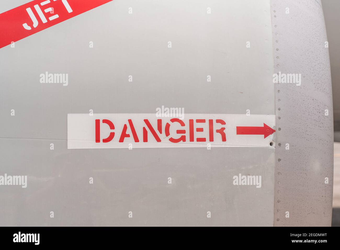 Closeup of "DANGER" painted in red on the jet engine with an arrow ...