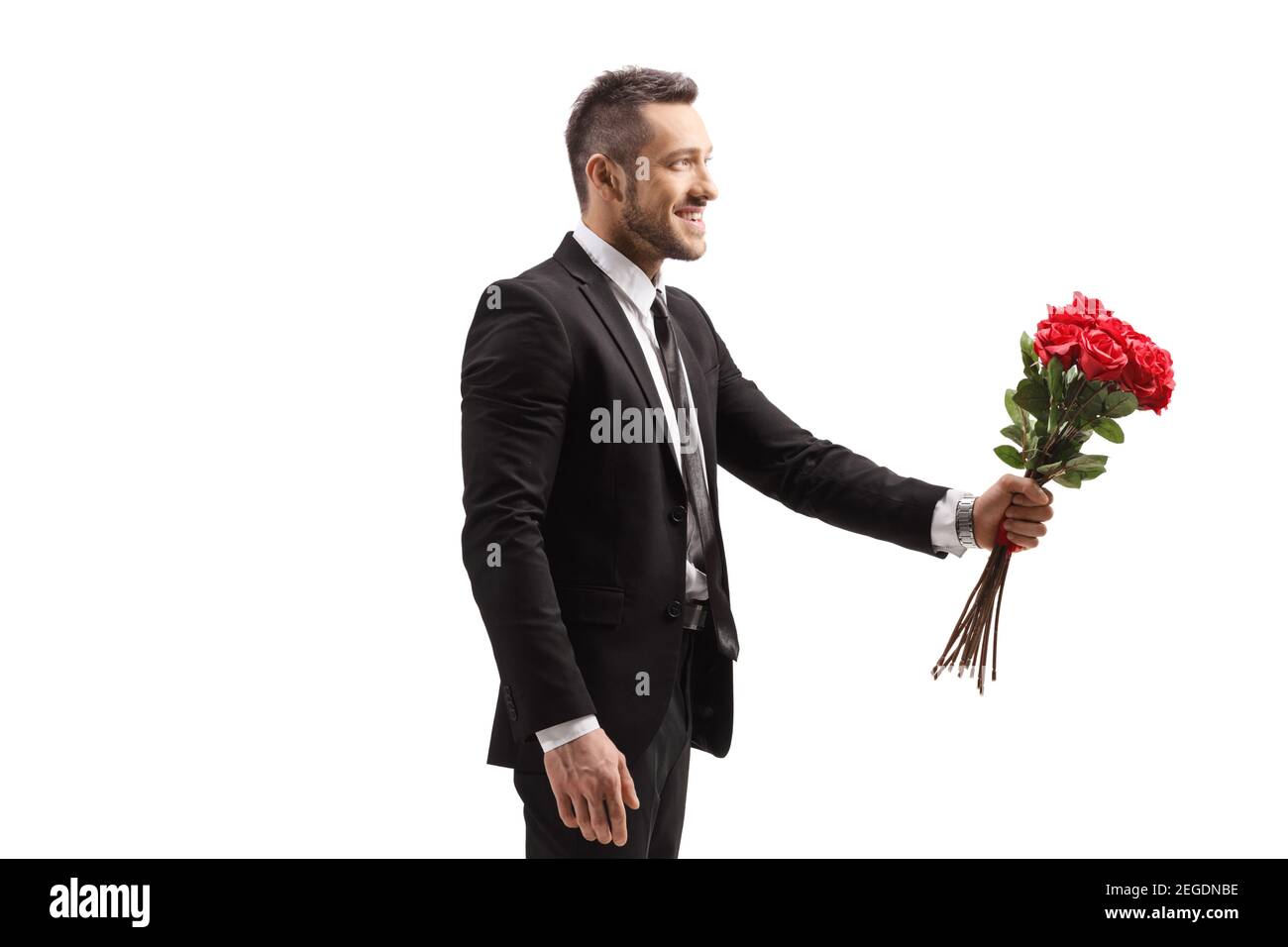 Romantic man smiling and giving a bunch of red roses isolated on white ...
