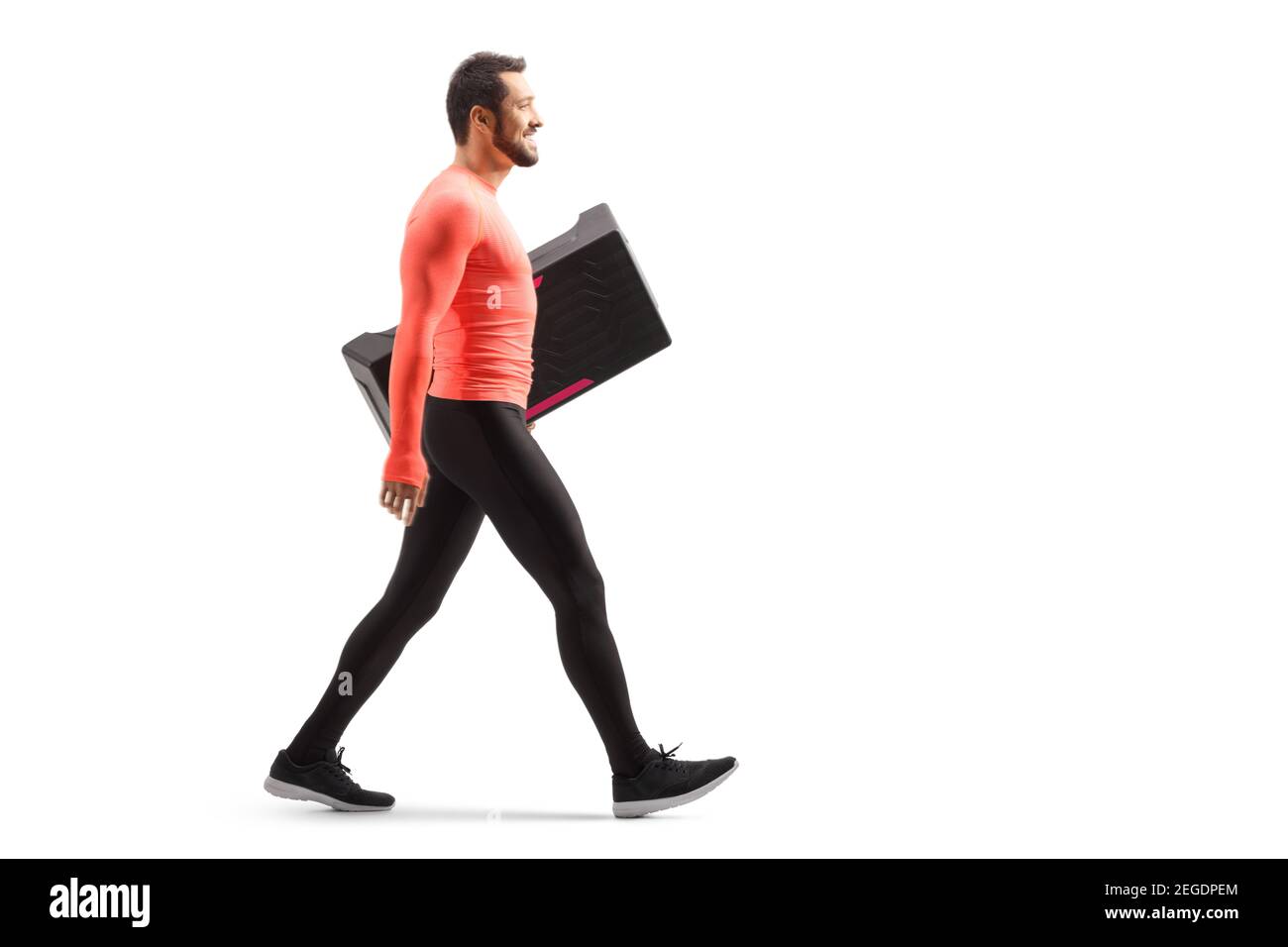 Full length profile shot of a smiling man walking and carrying an step ...