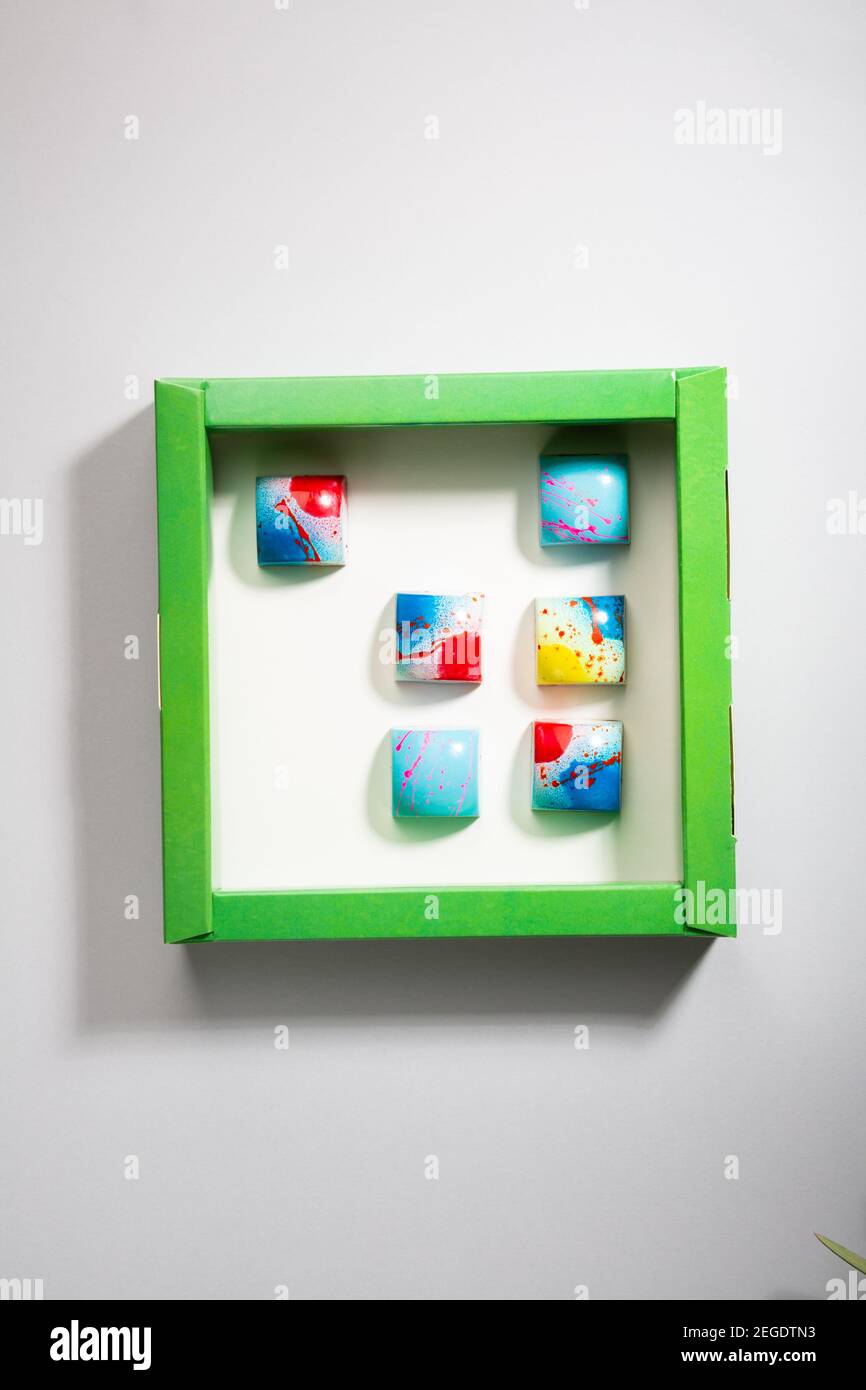 Sweet color chocolate candies in gift box Stock Photo - Alamy