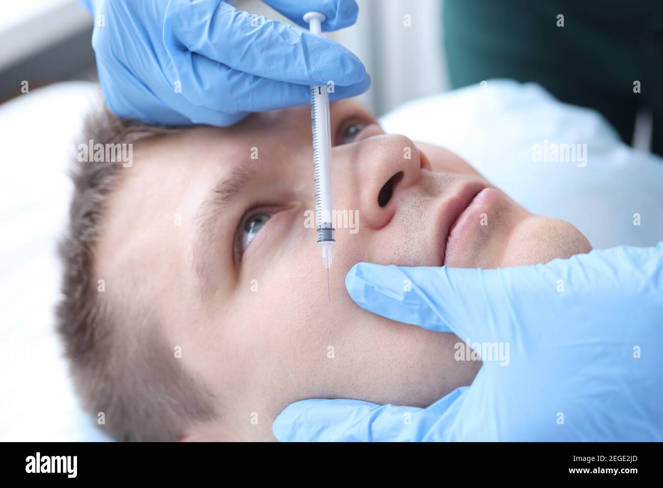 Beautician making injection into face of male patient Stock Photo - Alamy