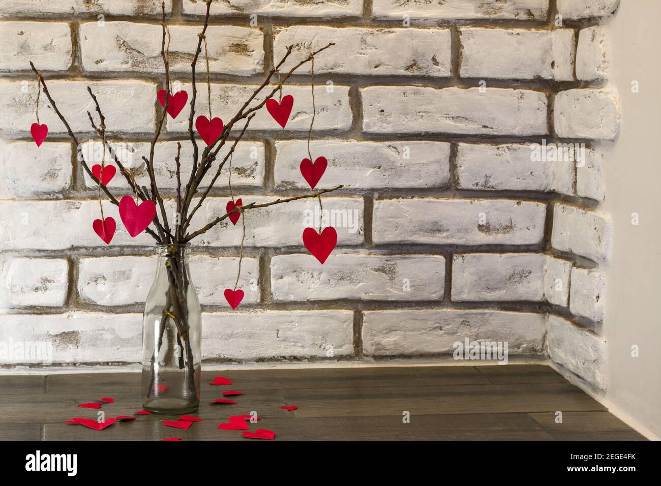 Branches and fallen hearts bouquet on white brick wall background Stock ...