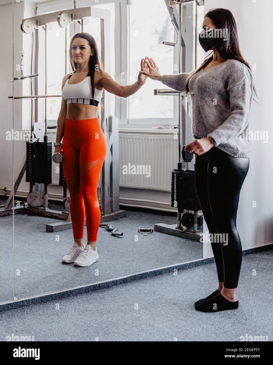 gym closed due to covid-19 virus. Woman in the reflection of a mirror ...