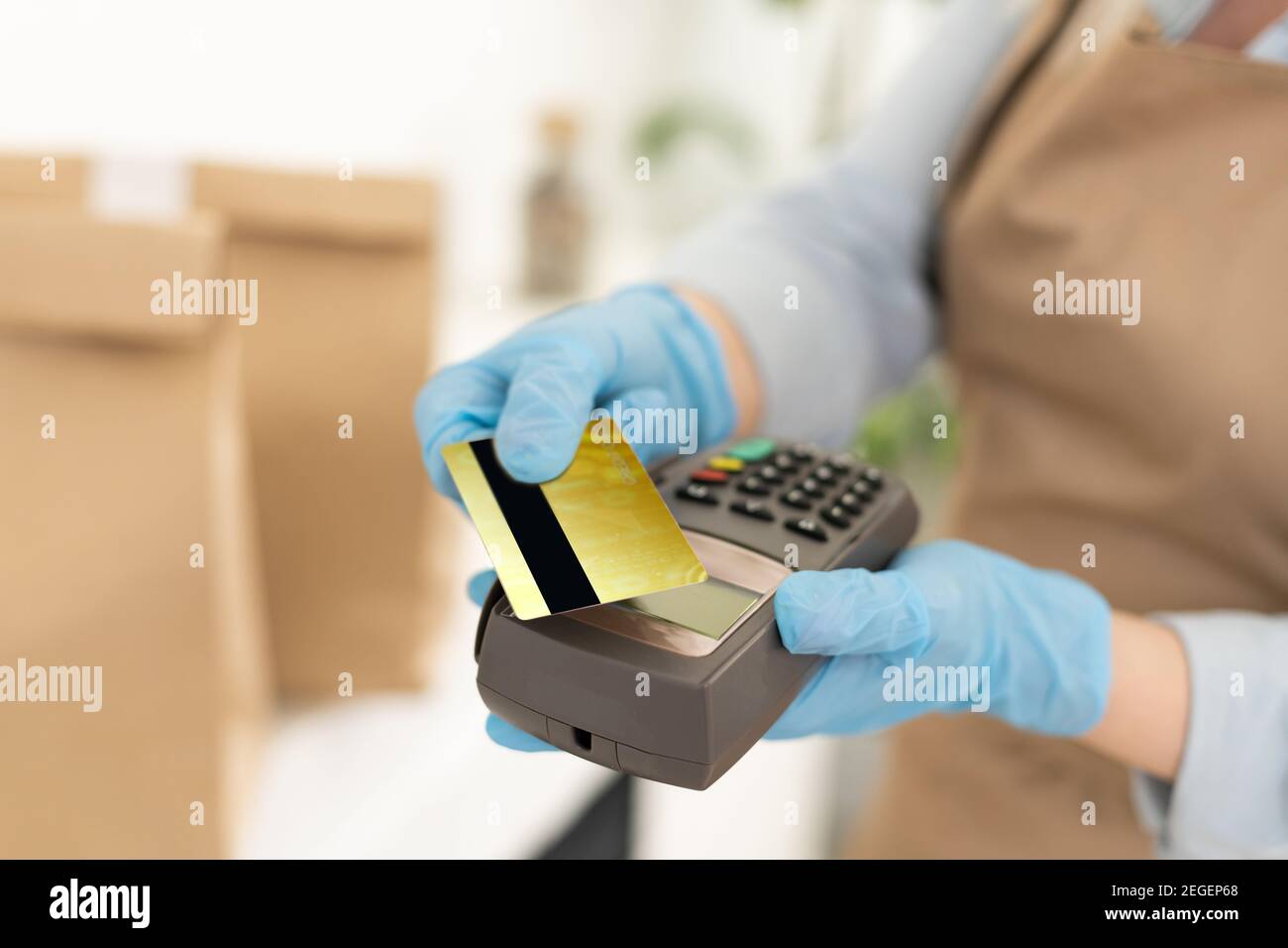 masked blonde girl with pos terminal Stock Photo - Alamy