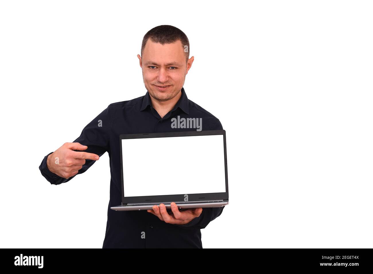 Smiling man pointing his finger at a blank laptop computer screen ...