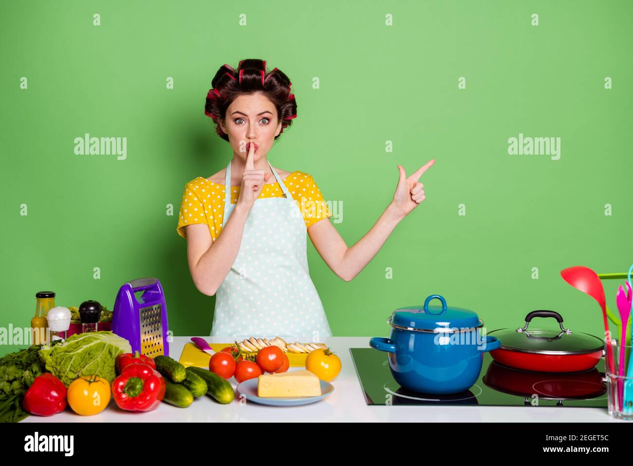 Astonished girl chef point index finger copyspace lips mouth dont share ...