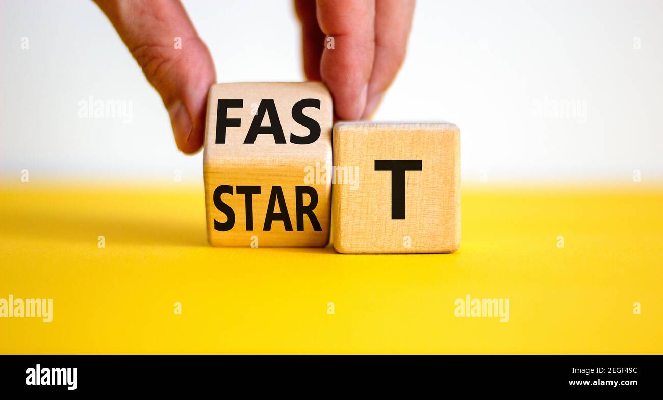 Time to fast start symbol. Businessman turns a wooden cube with words ...