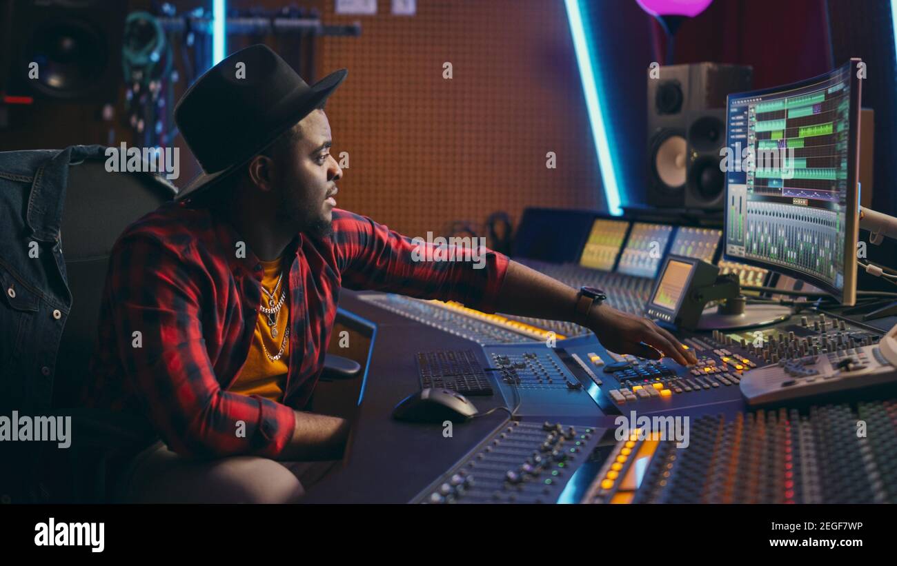 Stylish Audio Engineer Working in Music Recording Studio, Uses Mixing ...