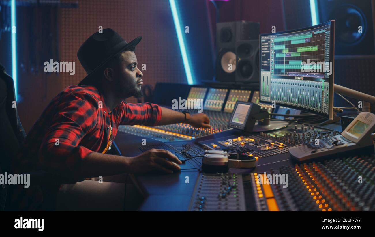 Stylish Audio Engineer Working in Music Recording Studio, Uses Mixing ...