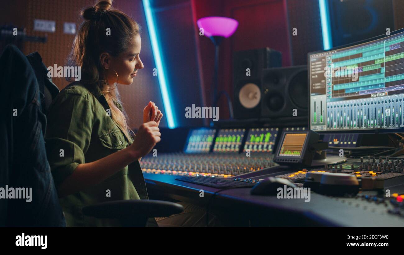 Stylish Female Audio Engineer Working in Music Recording Studio, Uses ...