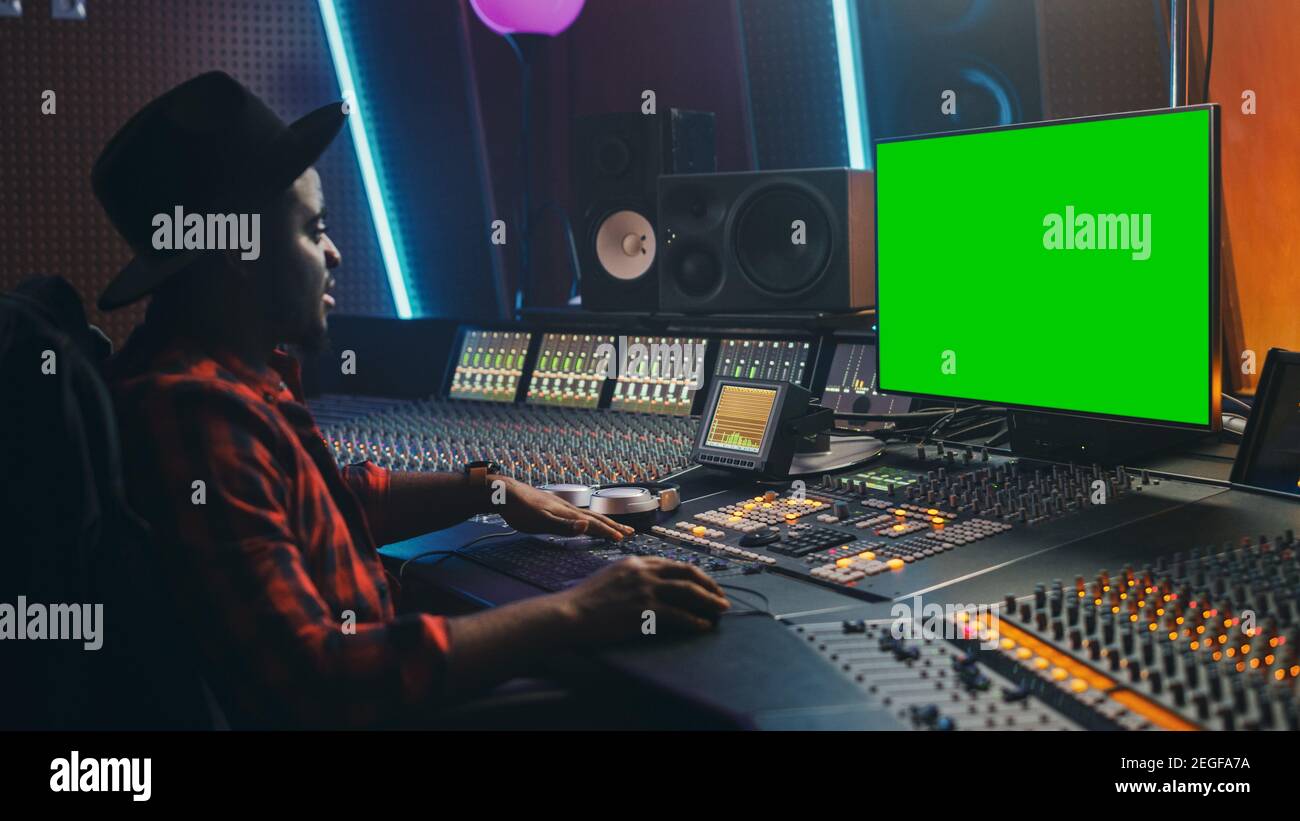 Stylish Audio Producer Working in Music Record Studio, Uses Green ...