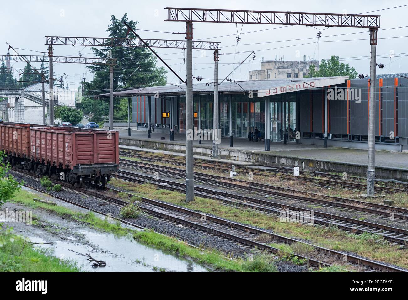 Kutaisi Train Station with few passengers (unrecognizable). It's ...