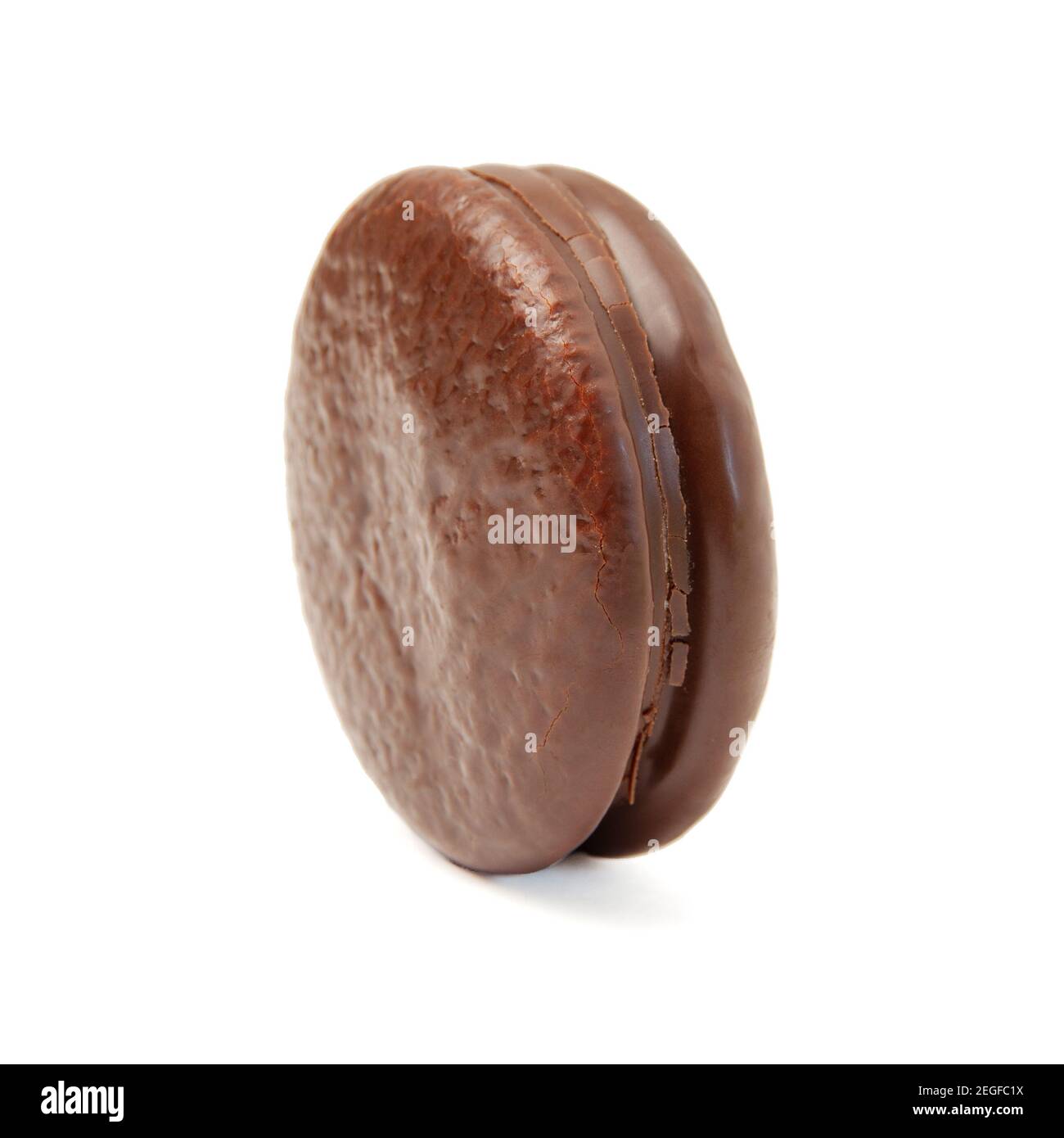 A piece of round chocolate cake chokopie isolated on a white background ...