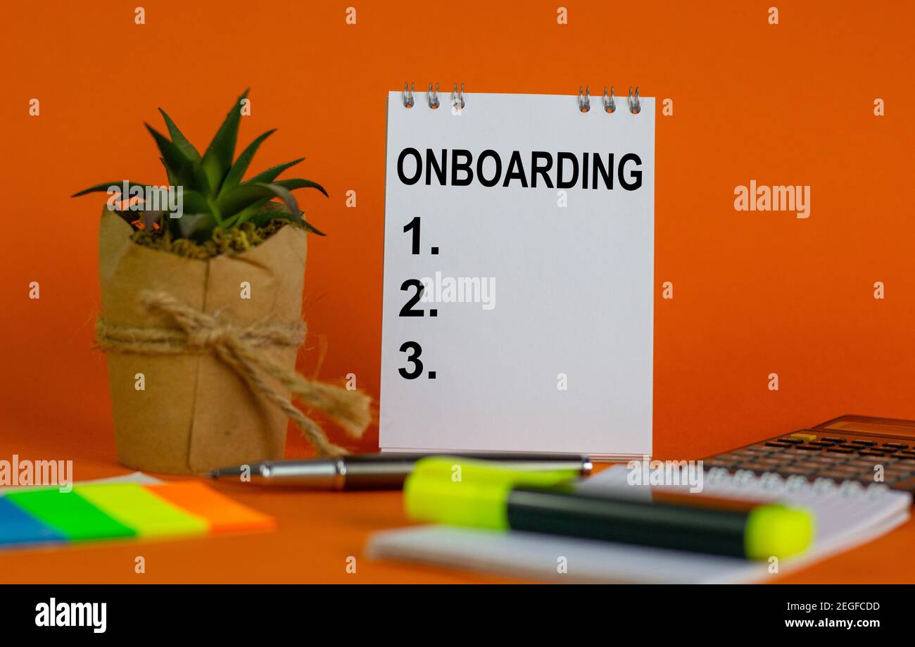 Onboarding symbol. White note with a word 'onboarding' on beautiful ...