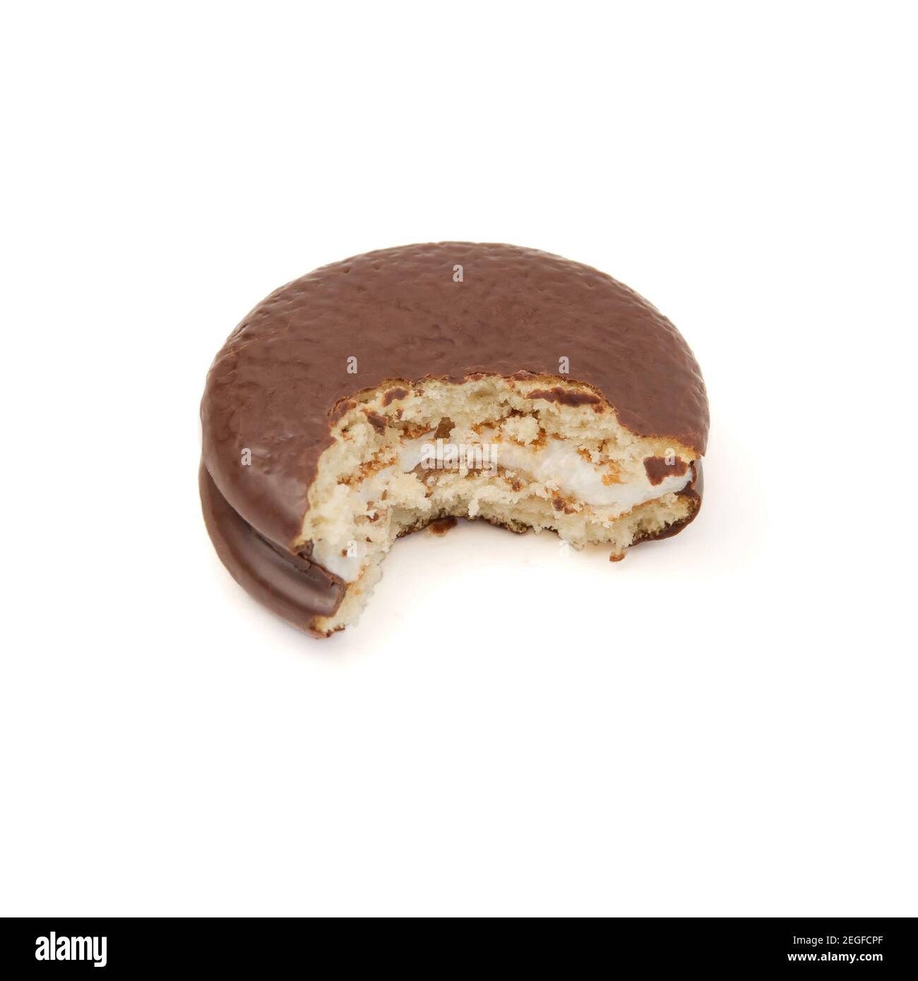 A piece of chocolate cake chokopie bitten off isolated on a white ...