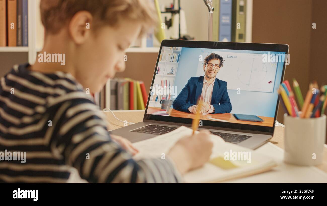 Smart Little Boy Uses Laptop for Video Call with His Teacher. Screen ...