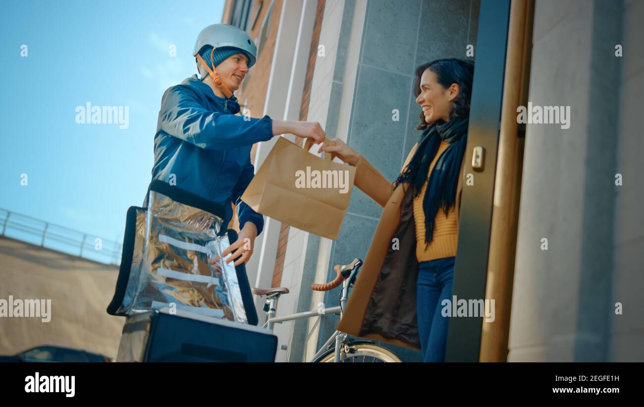 Happy Food Delivery Man Wearing Thermal Backpack on a Bike Delivers ...