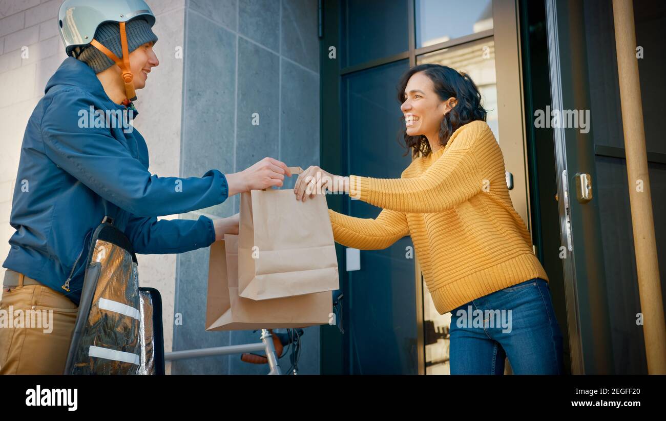 Happy Food Delivery Man on Bike Delivers Restaurant Order to Beautiful ...