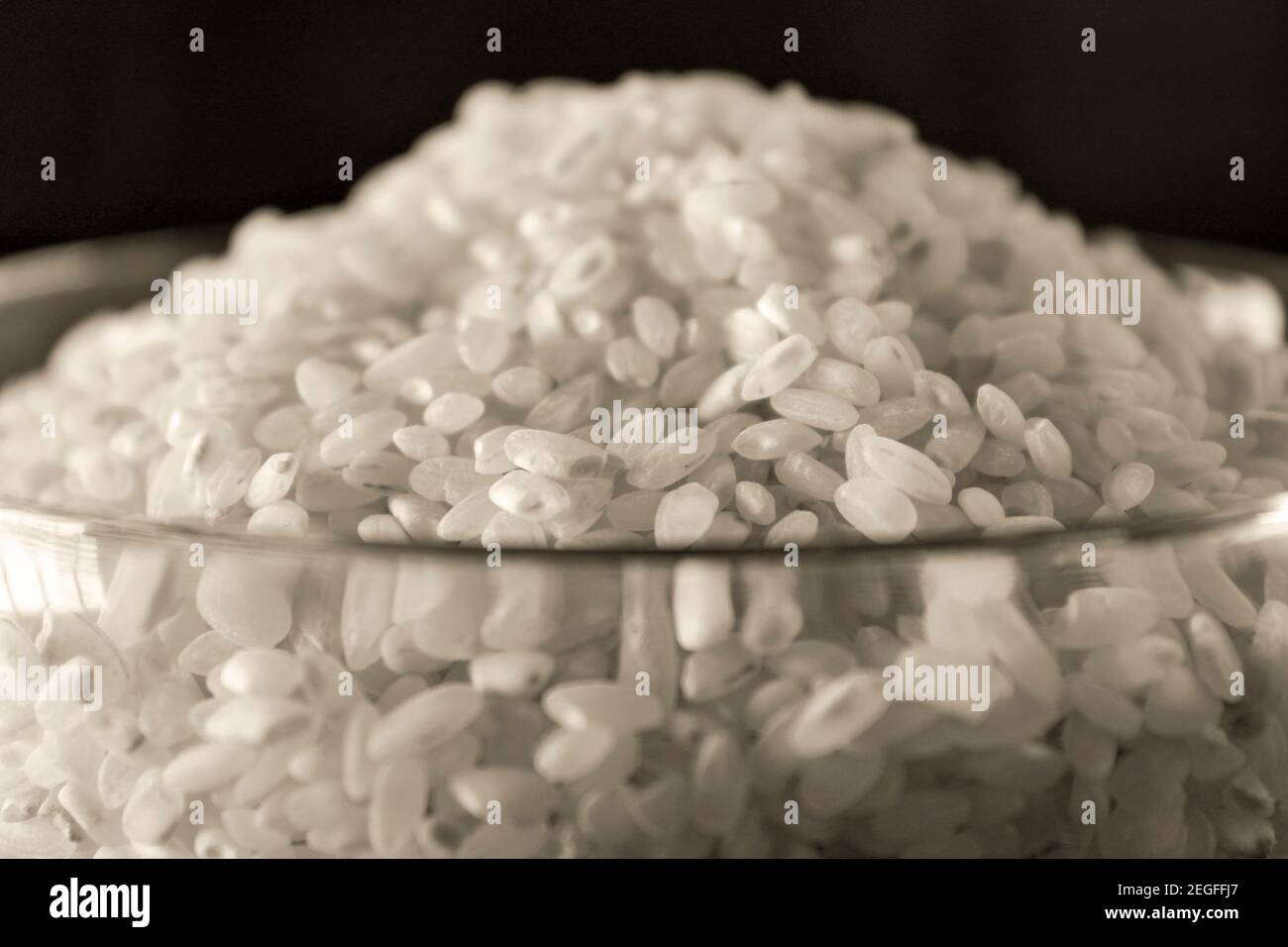 White rice texture and background in glass bowl. Grey background ...