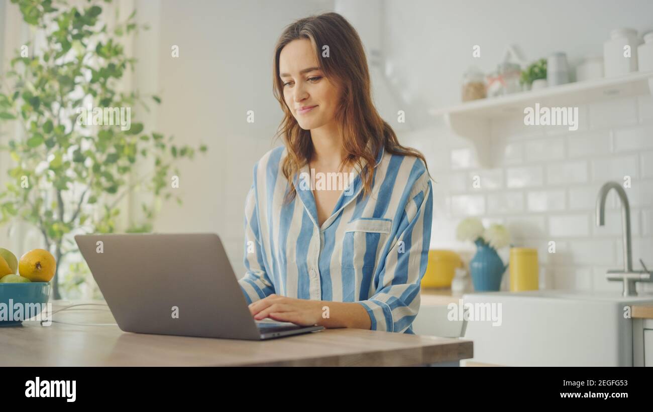 Young Beautiful Woman Using Laptop Computer While Wearing Blue Pyjamas ...