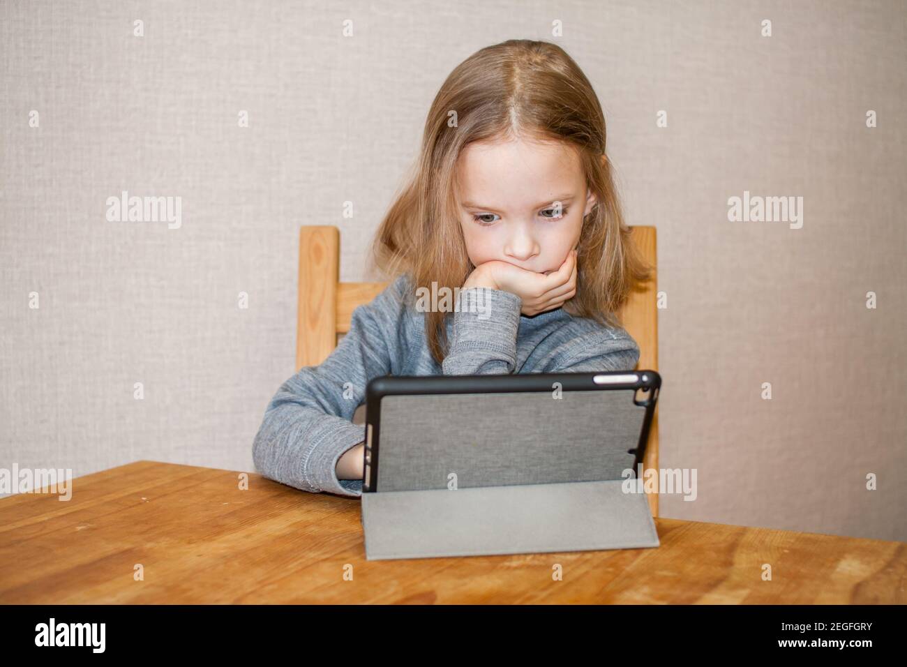 little girl is watching an online video tutorial. Remote training. Blog ...