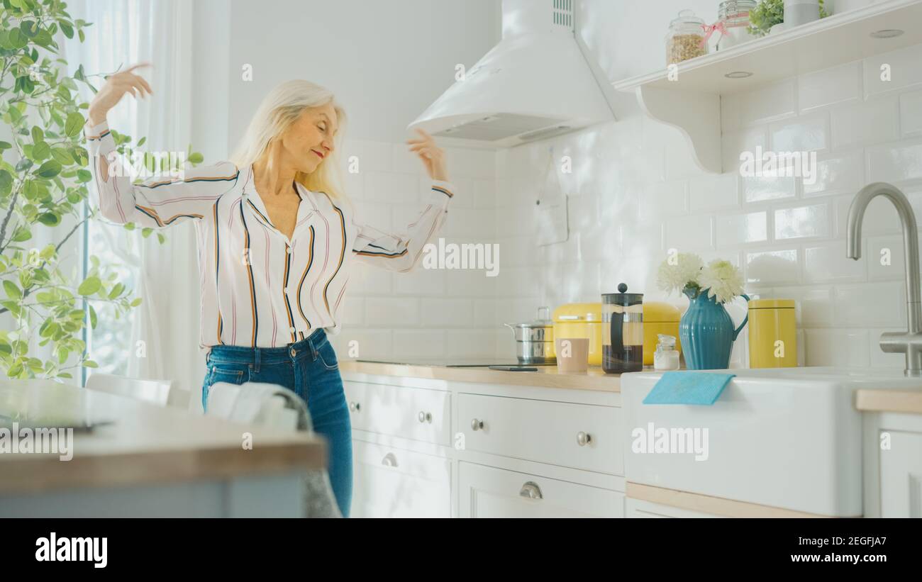 Authentic Senior Female in Blue Jeans and White Striped Blouse is ...
