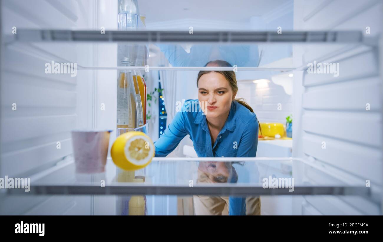 Dissappointed and Angry Young Woman Looks inside the Fridge, Checks Out ...