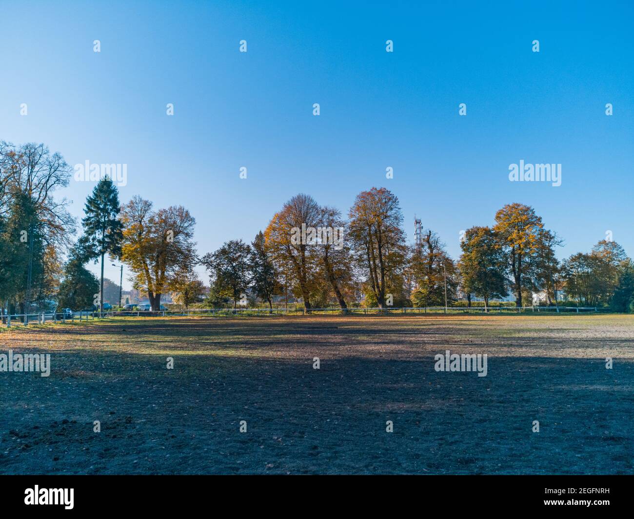 Empty paddock for horses with colorful fall trees around Stock Photo ...
