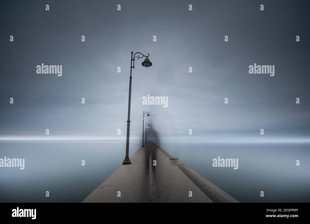 Ghost walking through a pier in the sea Stock Photo - Alamy