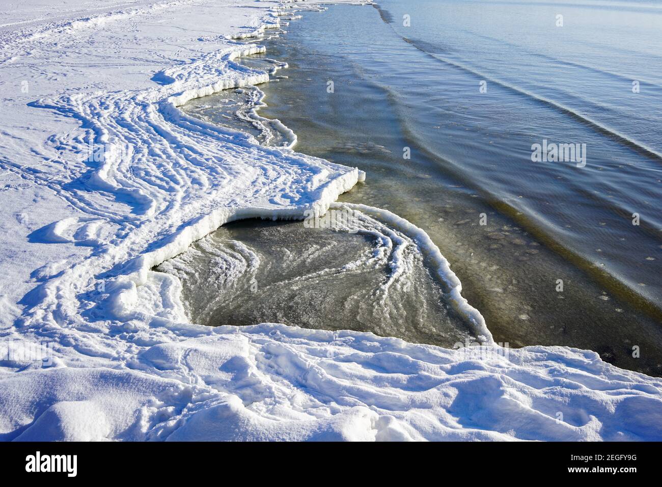 winter on the Baltic coast, snow, ice and water form the shoreline ...