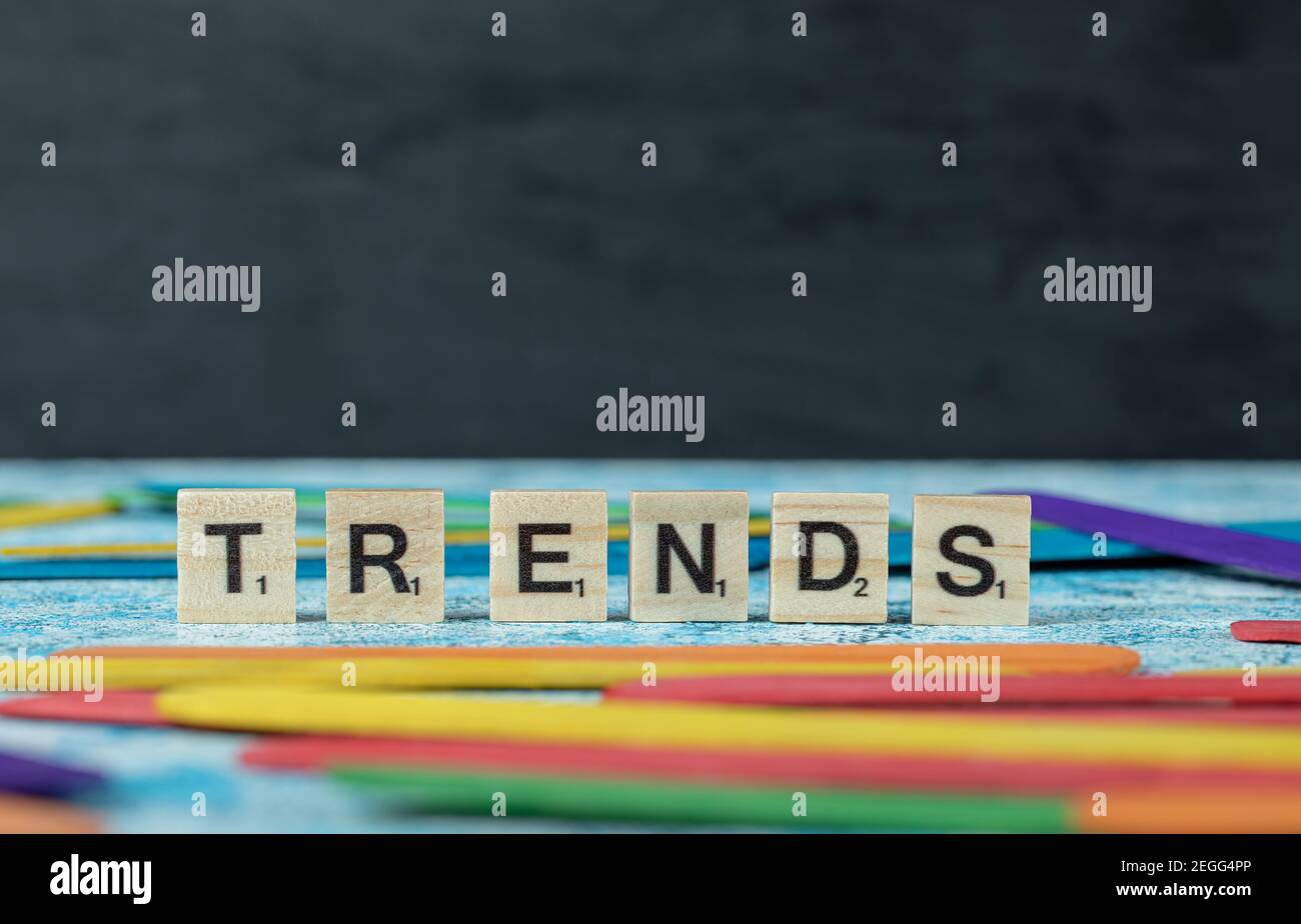 Trends writing with black letters on wooden dices on the blue ...