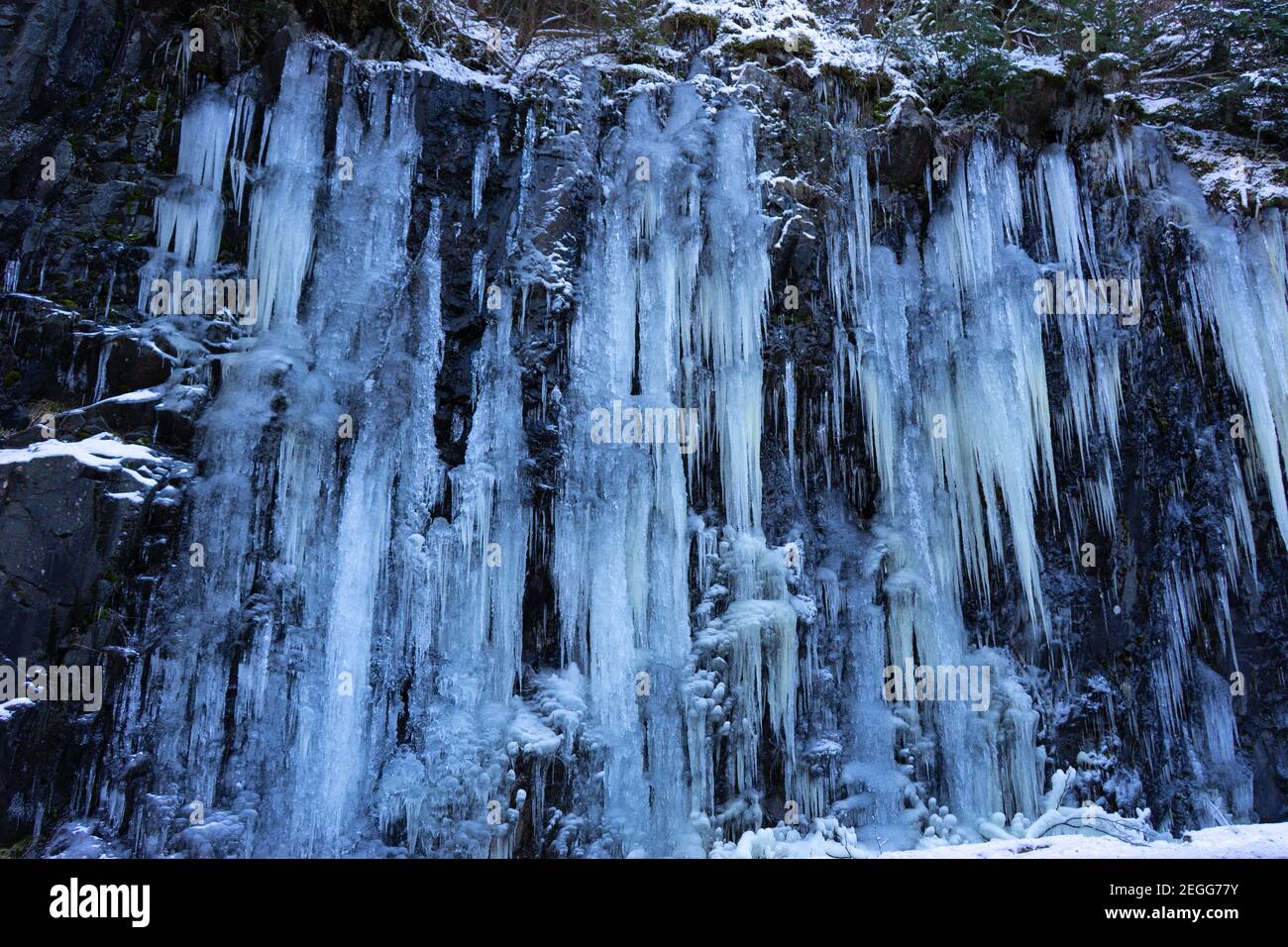 Rock cliff with ice stalactites in winter Stock Photo - Alamy