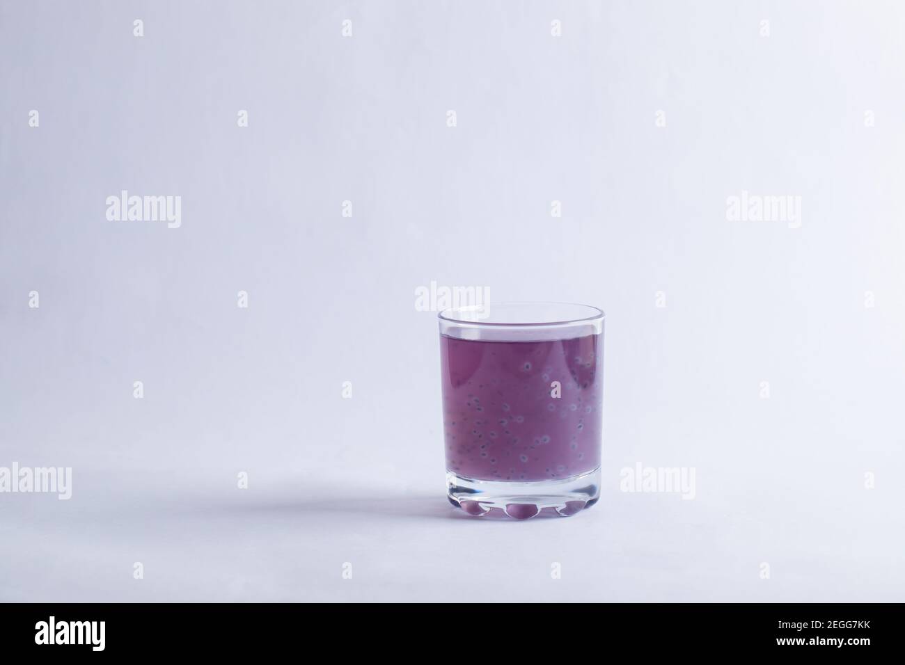 A glass of purple blueberry juice on grey background Stock Photo - Alamy