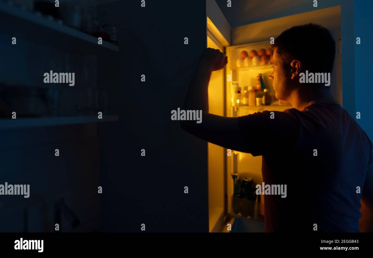 Man looking in fridge hi-res stock photography and images - Alamy