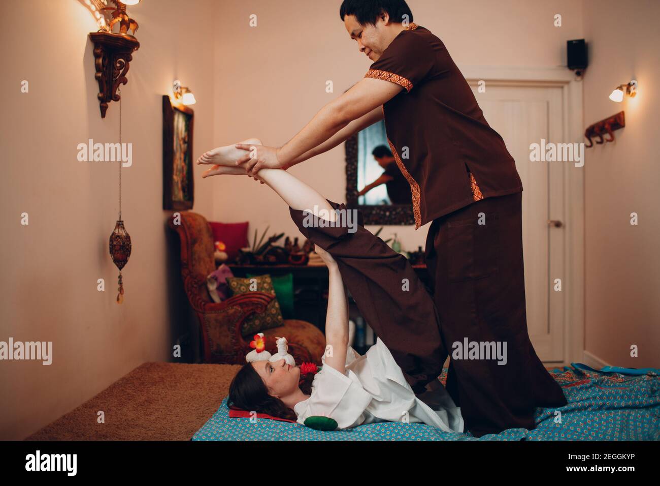 Thai man making classical thai massage procedure to young woman at ...