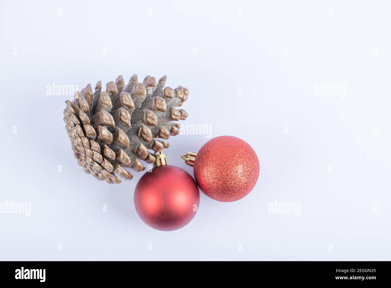 An oak tree cone with red glittering balls on a white background Stock ...