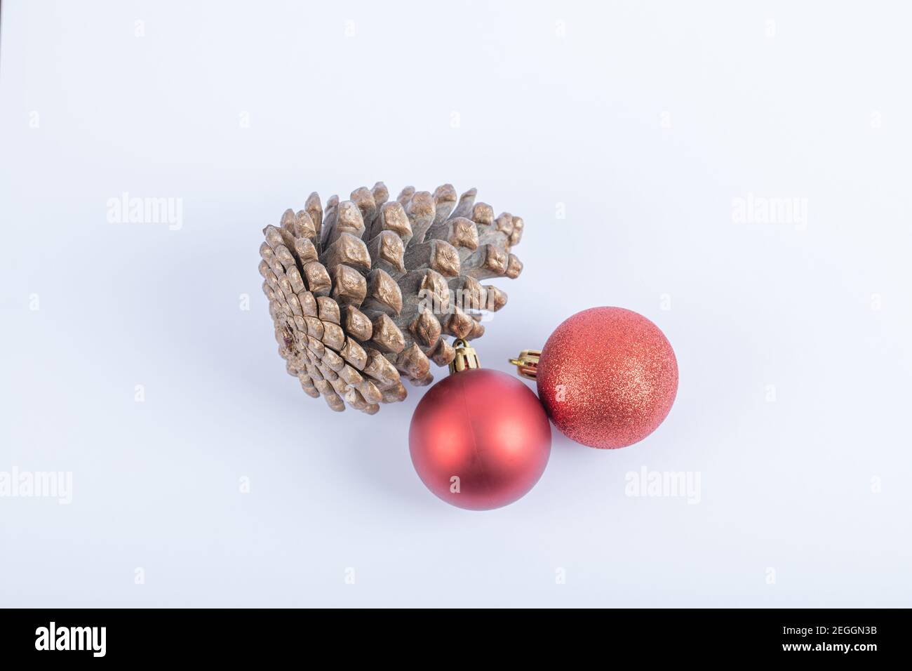 An oak tree cone with red glittering balls on a white background Stock ...