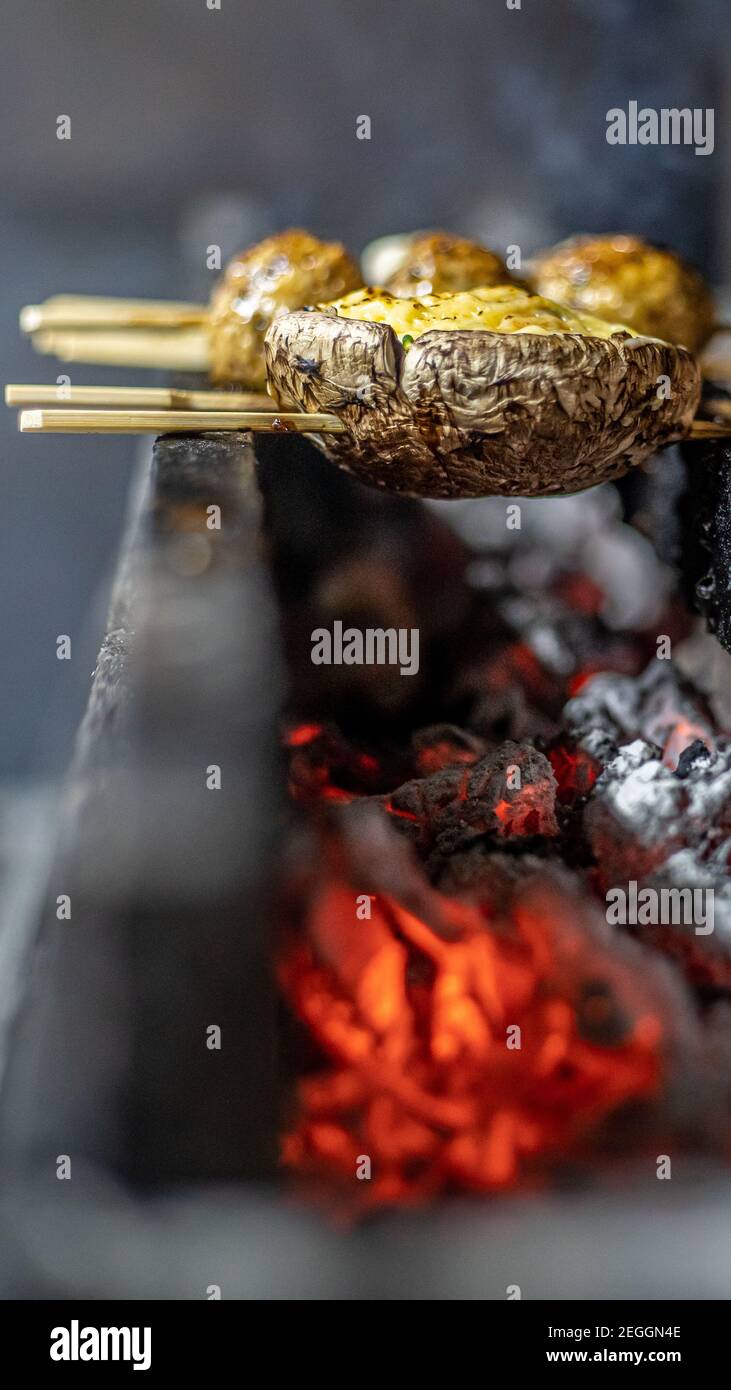 Closeup shot of wooden sticks with vegetables and meat on barbecue ...