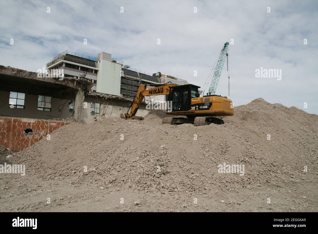 Excavator at site, post-disaster construction and demolition ...