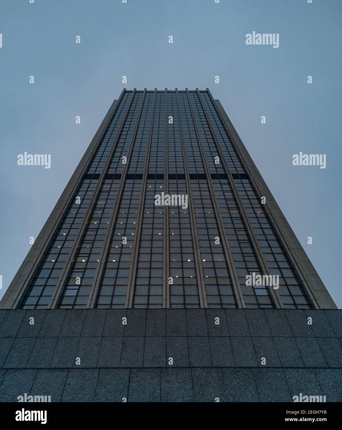 Upward view to high skyscraper full of offices Stock Photo - Alamy