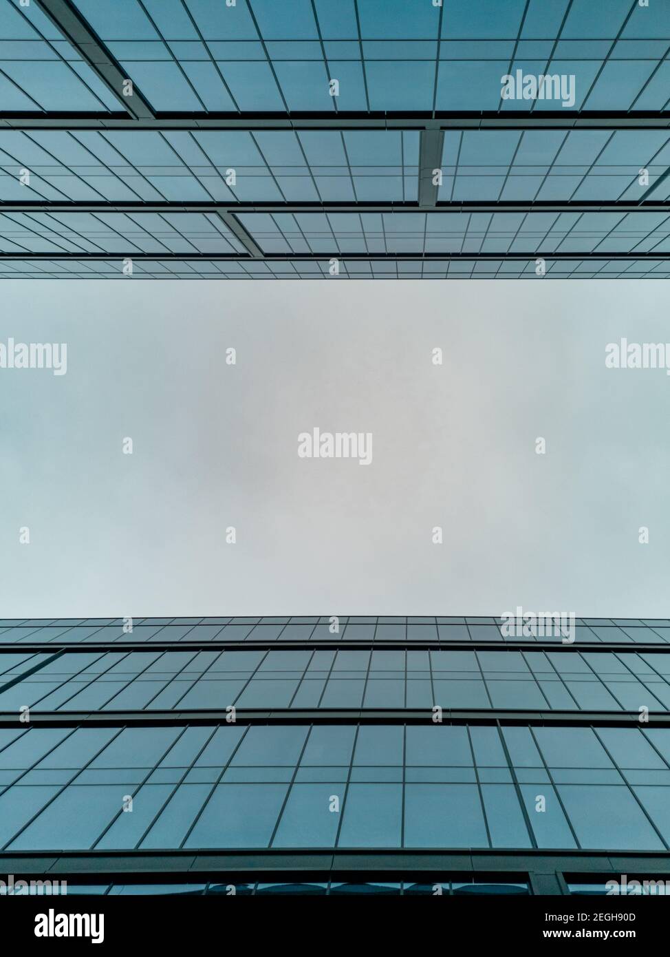 Upward view to two high corporate buildings full of windows Stock Photo ...