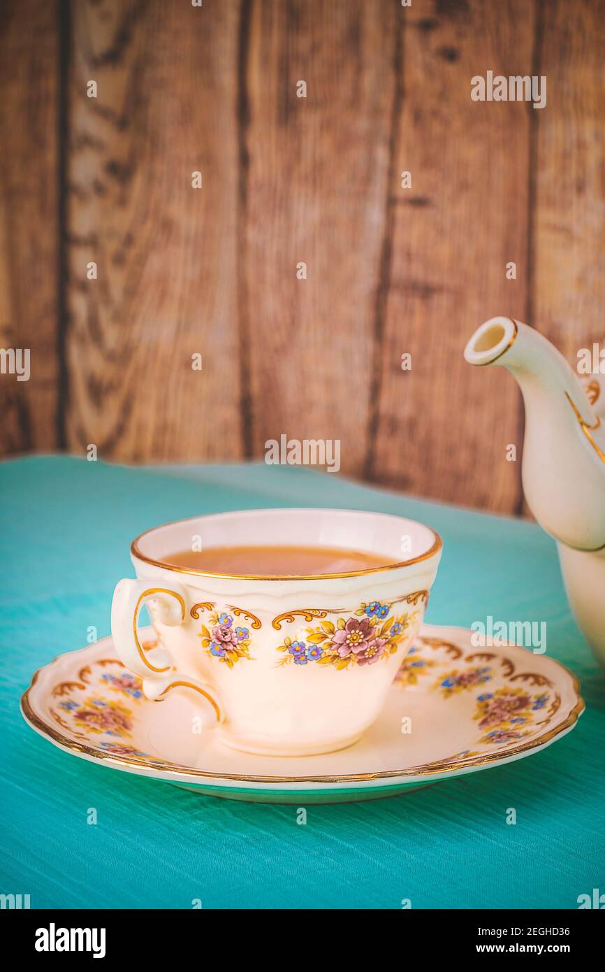 View of a cup of tea and a fine china teapot on a table at sunset Stock ...