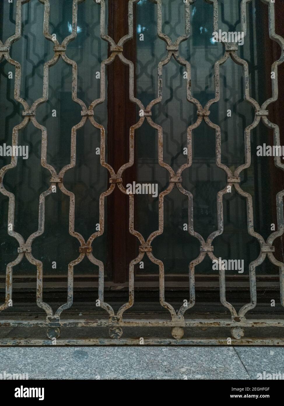 Metal ornamental lattice in front of old window Stock Photo - Alamy