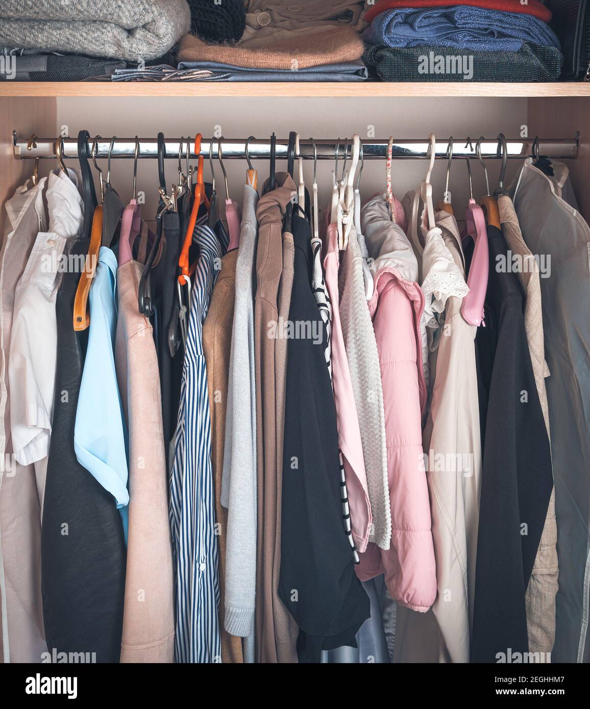 Women's clothing hangs on hangers in the closet Stock Photo - Alamy